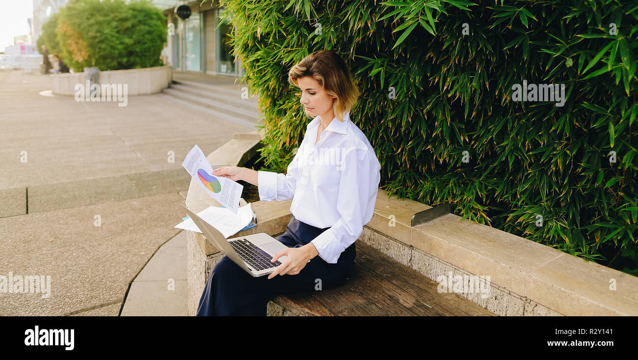 Statistician working outside with laptop and color diagrams Stock Photo ...