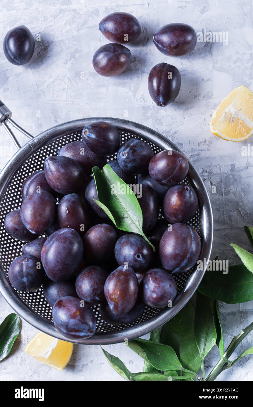 Flat lay view of ripe plums, on old wooden white background Stock Photo ...
