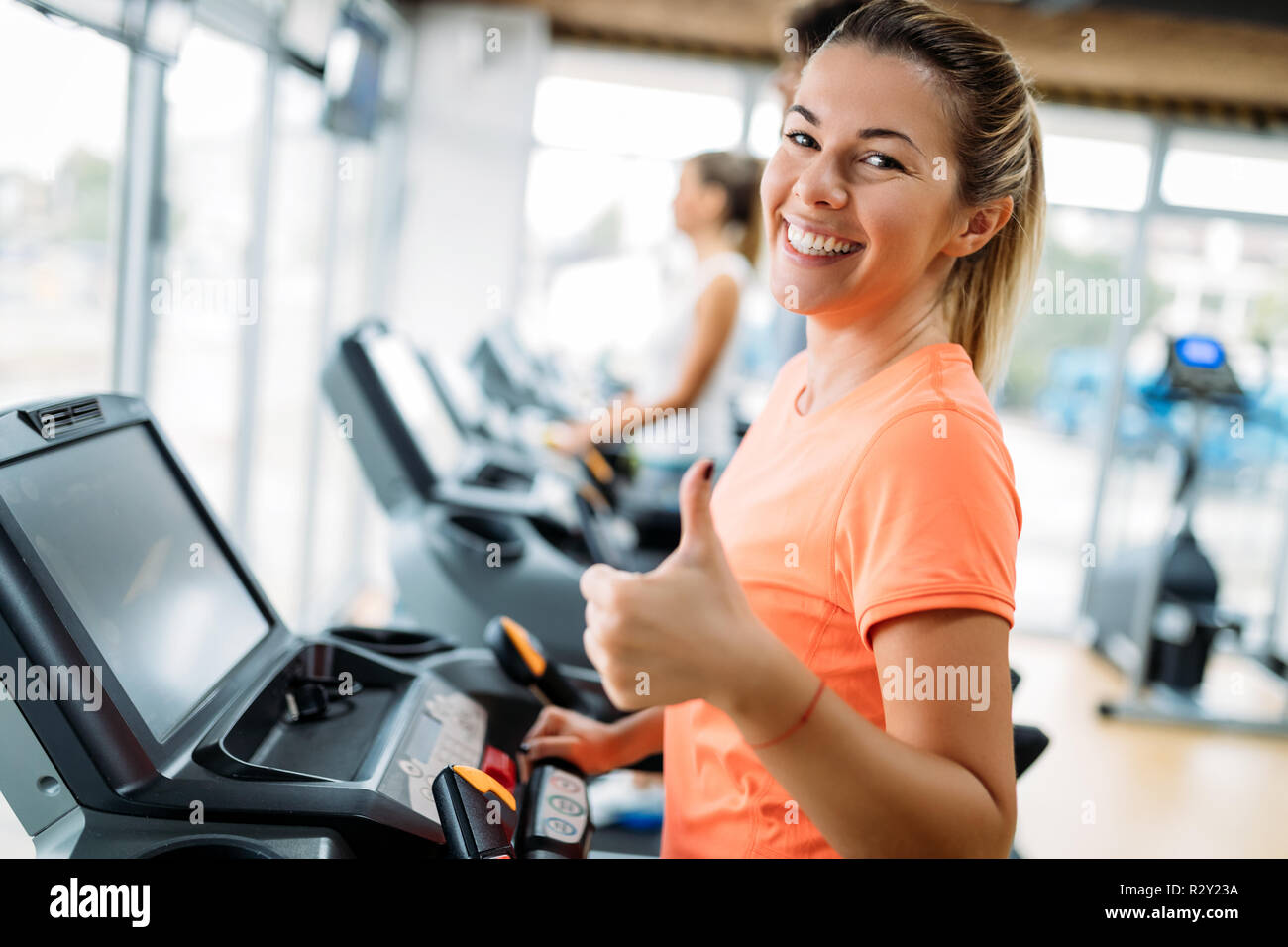 Group of friends exercising on treadmill machine Stock Photo - Alamy