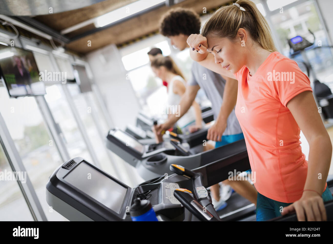 Young and beautiful lady running on a treadmill and sweating Stock ...
