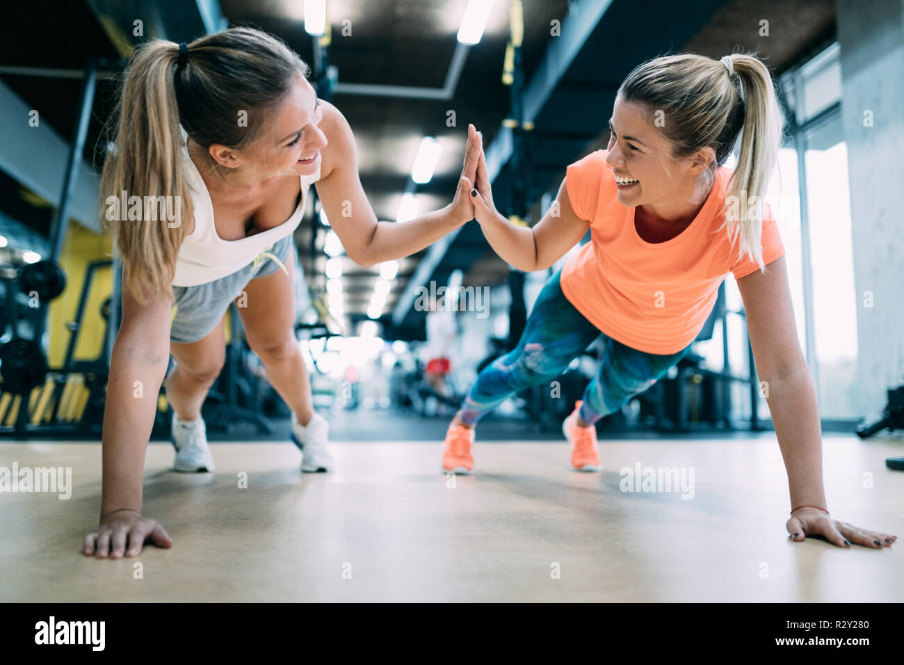 Beautiful young women working out in gym Stock Photo - Alamy