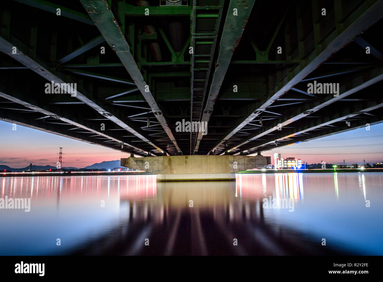 A landscape long exposure under a bridge forming line patterns. This ...