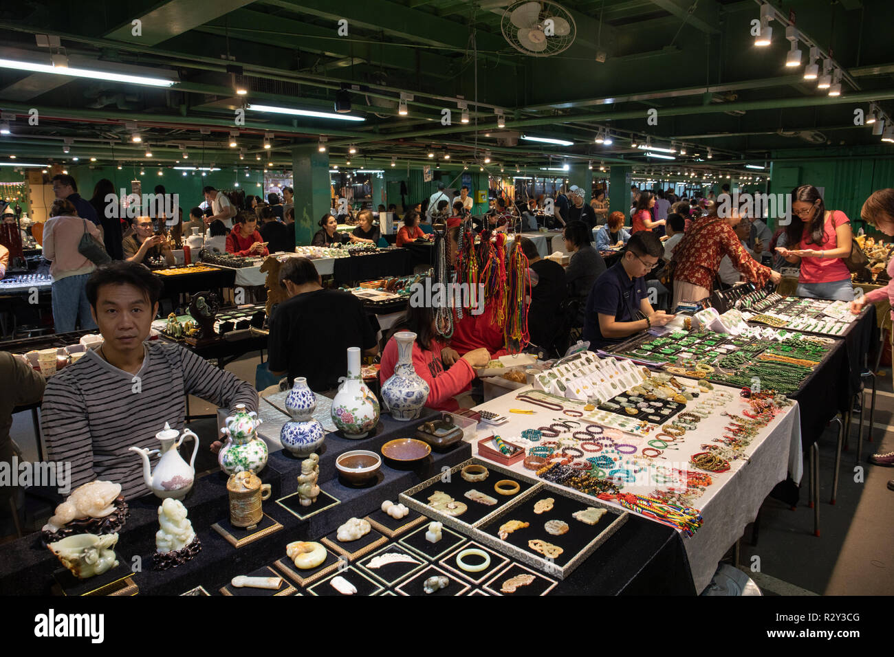 Vendors sit behind their booths at the Jianguo Holiday Jade Market in ...
