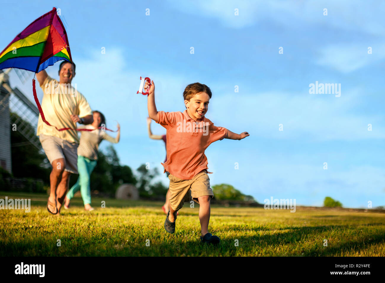 Little boy flying a kite with his parents Stock Photo - Alamy