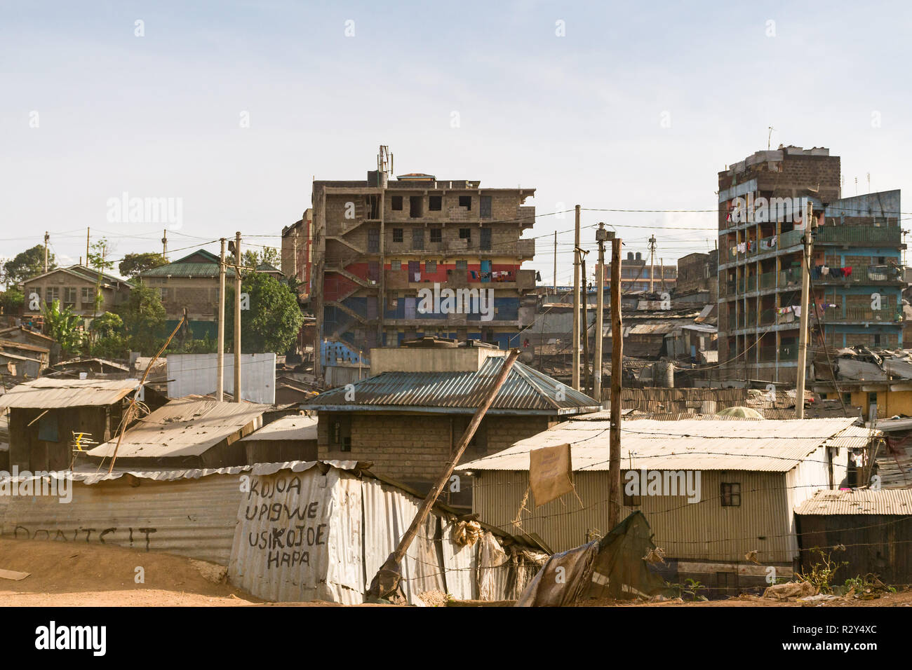 Mathare slum with view towards apartment blocks in late afternoon light ...