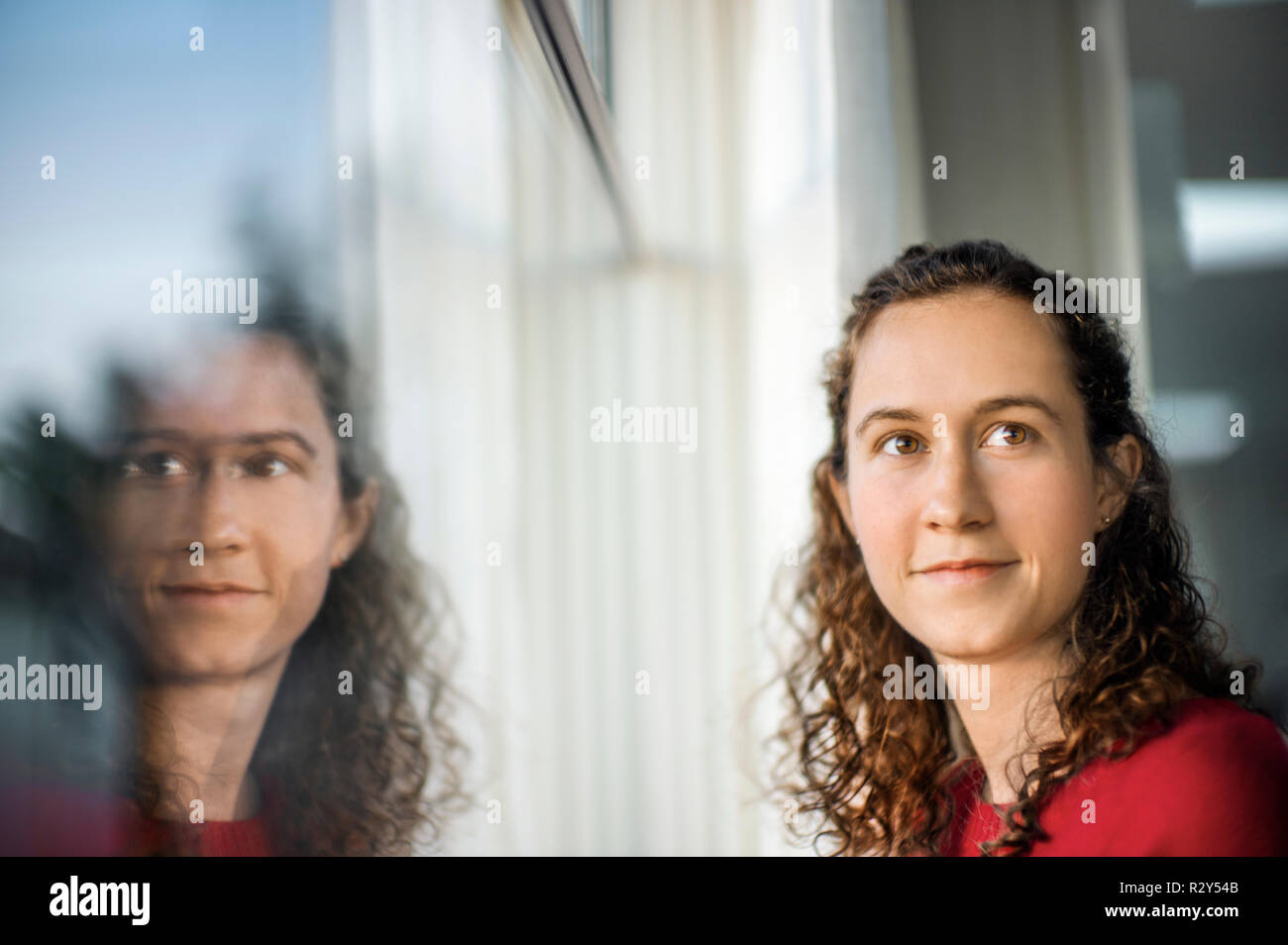 Young woman reflected in a window Stock Photo - Alamy