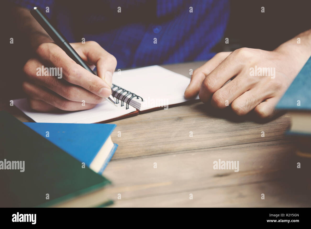 Books desk pen hand hi-res stock photography and images - Alamy