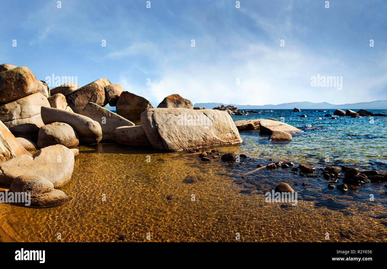 Large rocks in the shallows of a beach Stock Photo - Alamy