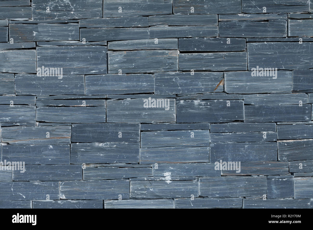 Detail of a dark stone wall background Stock Photo - Alamy