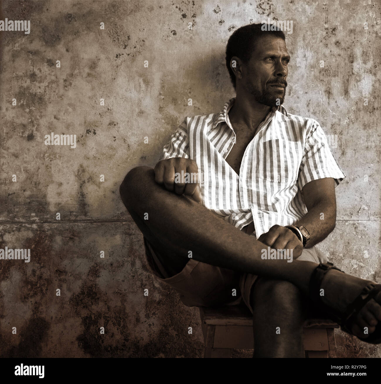 Serious man sitting on stool hi-res stock photography and images - Alamy