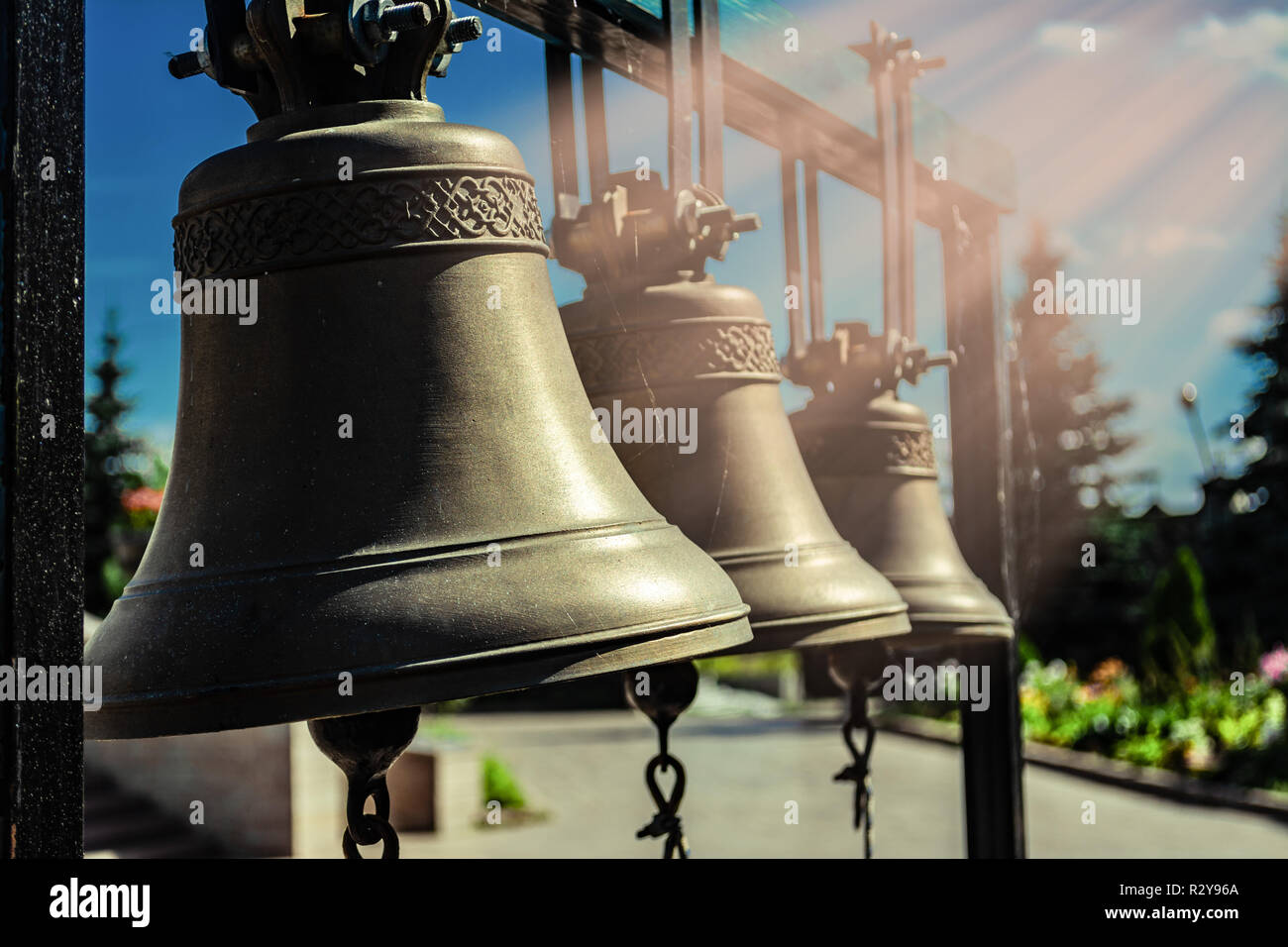 Three church bells in the sun rays Stock Photo - Alamy