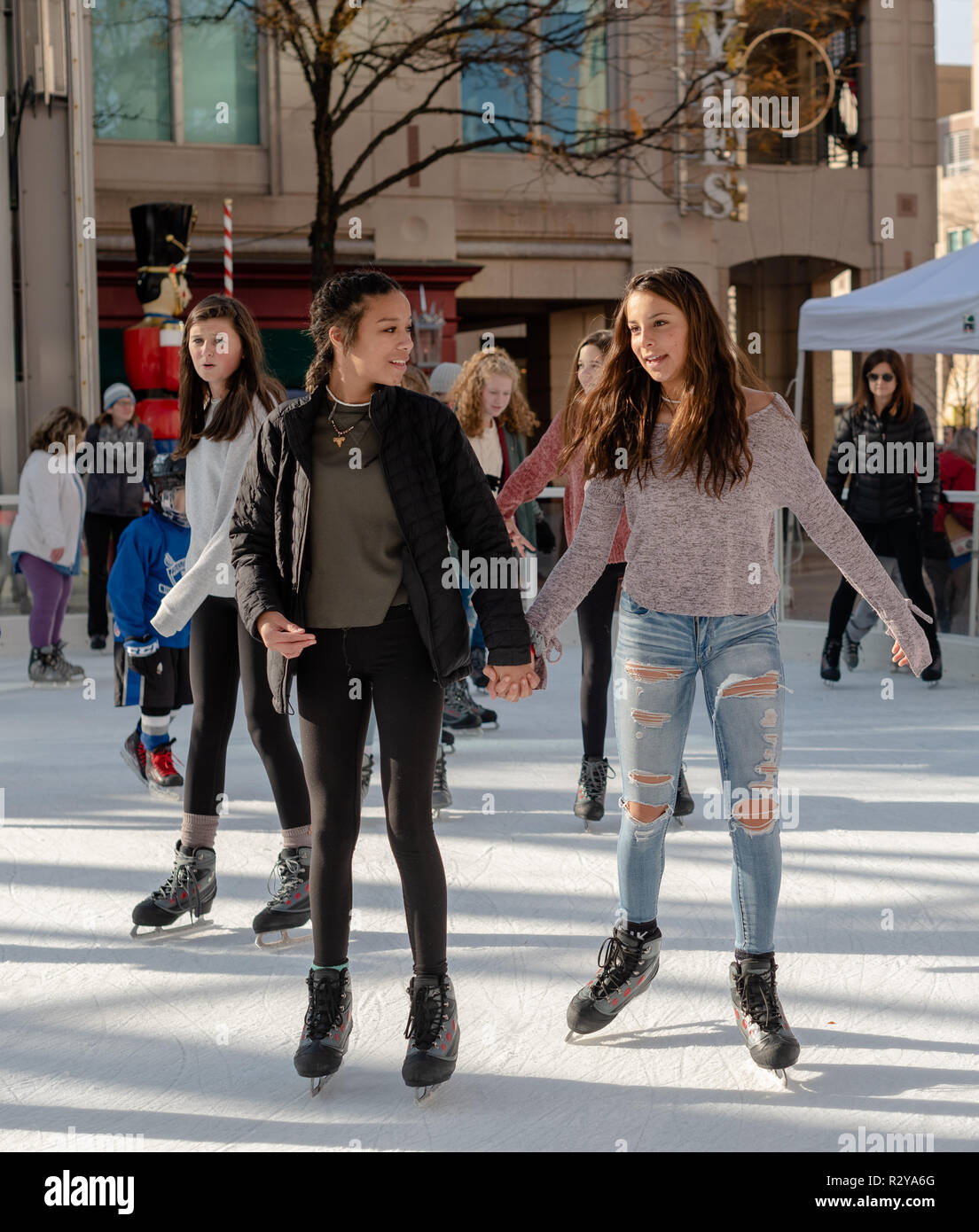 Reston VA -- November 17, 2018. A young woman and girl are ice skating ...
