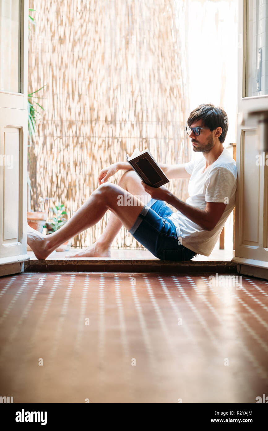 Boy reading book on porch hi-res stock photography and images - Alamy