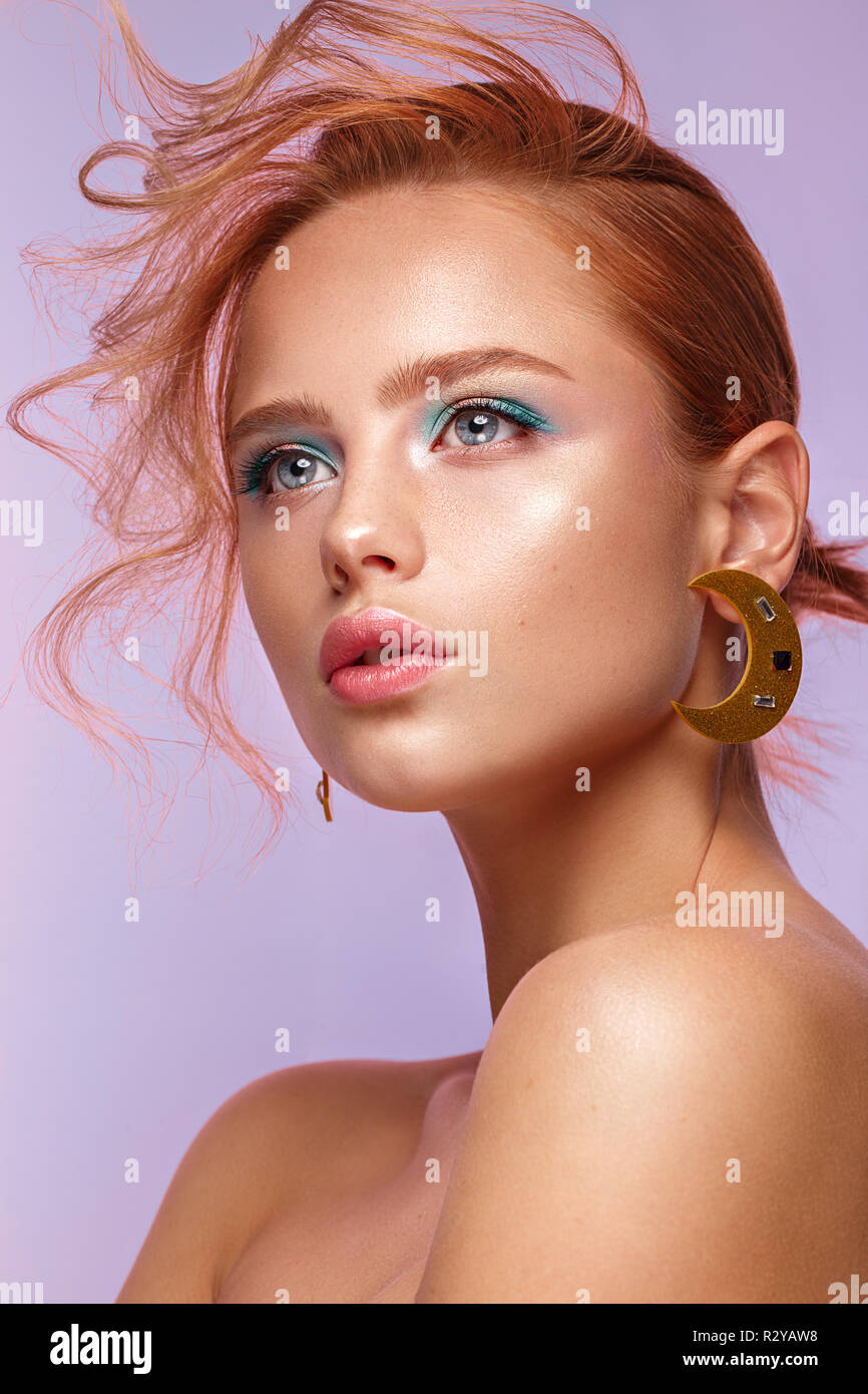 Beautiful girl with unusual accessories and make-up on a bright ...