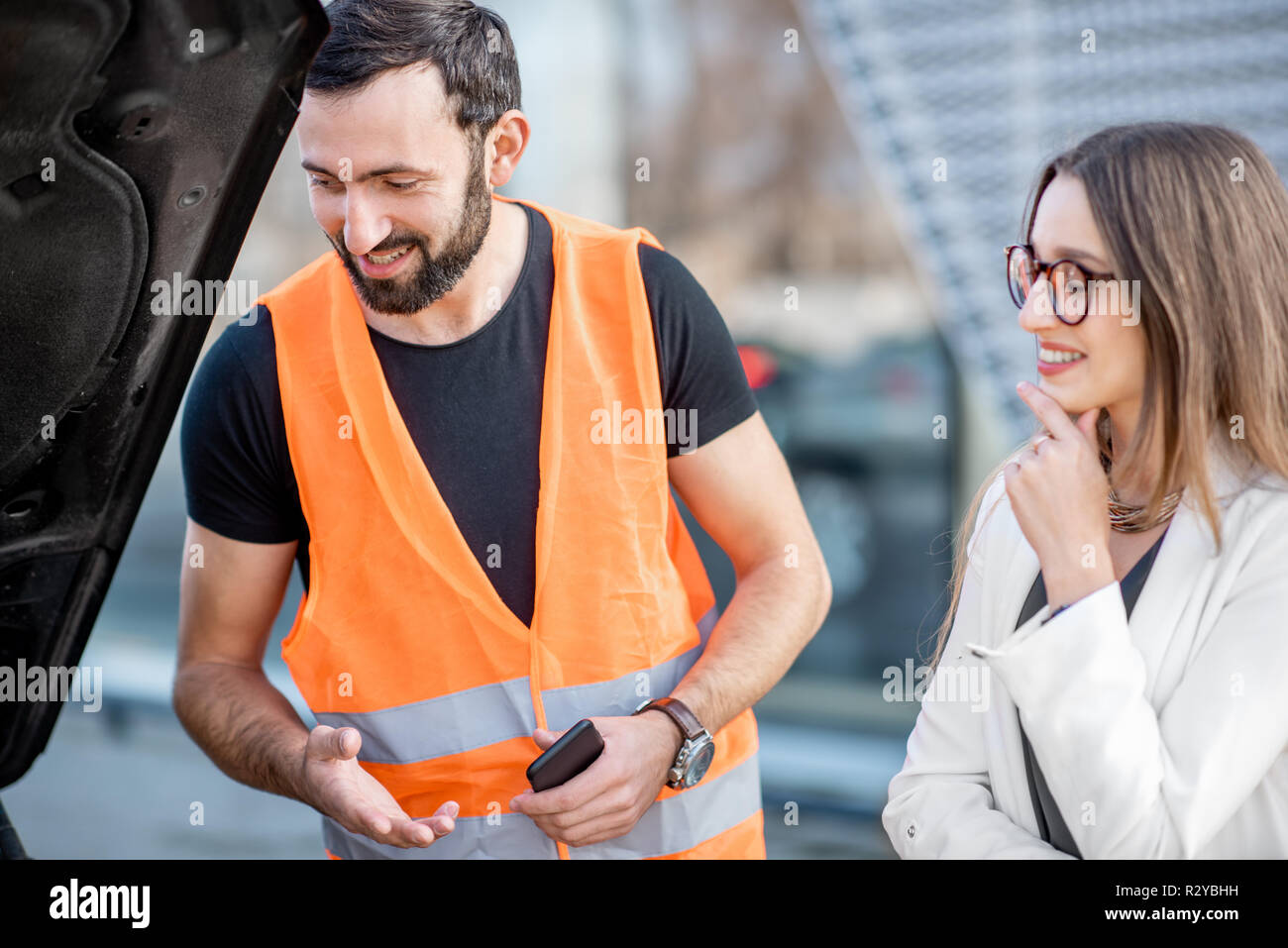 Handsome service worker consulting or providing technical assistance of ...