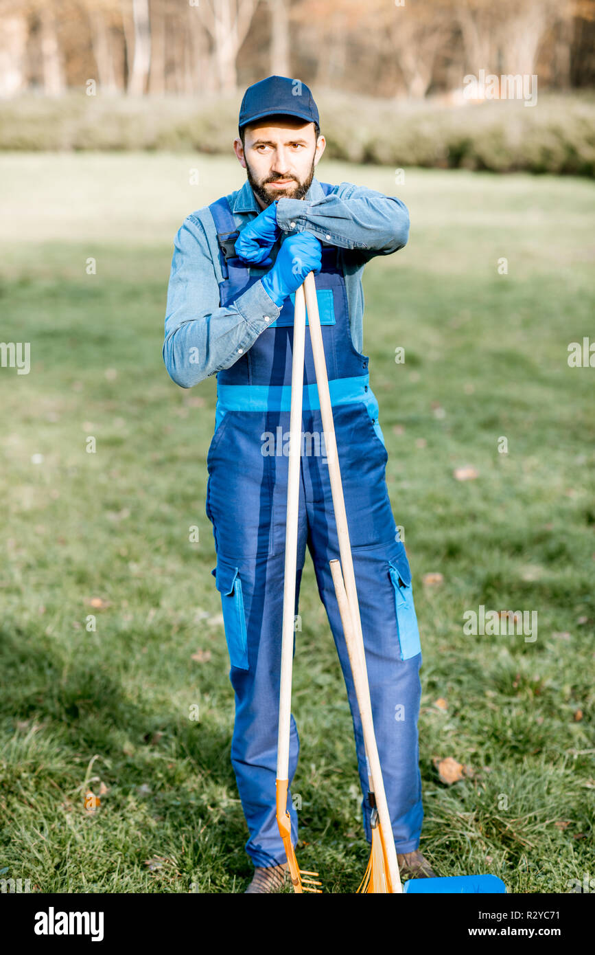 Portrait of a male sweeper in uniform with working tools outdoors Stock ...
