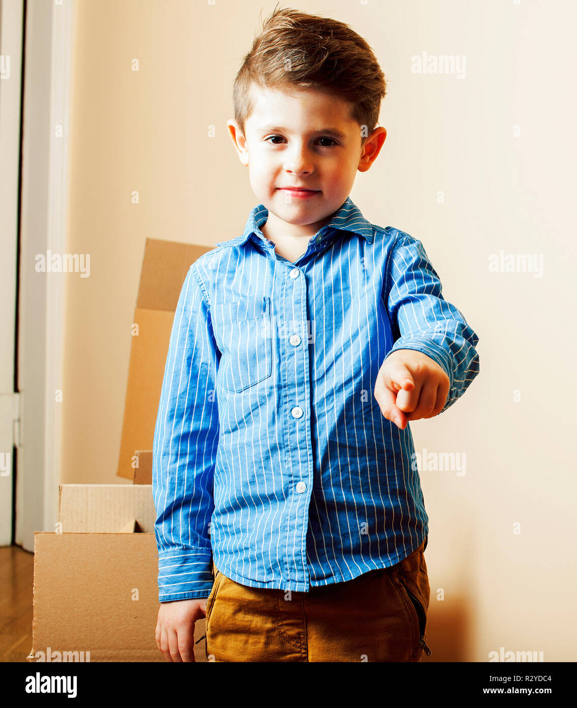 little cute boy in empty room, remoove to new house. home alone Stock ...