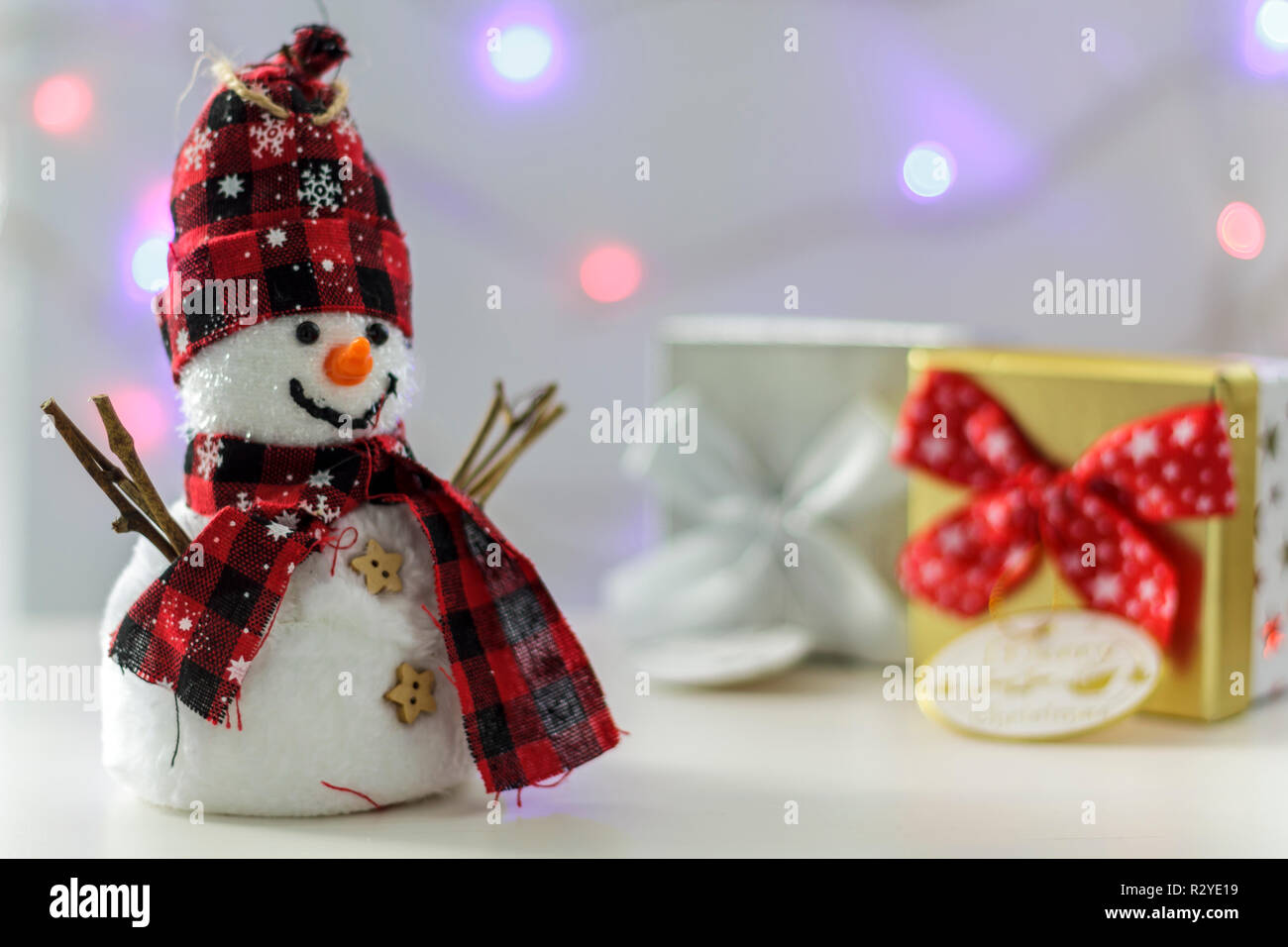 Snowman with gift boxes and christmas lights on the background Stock ...
