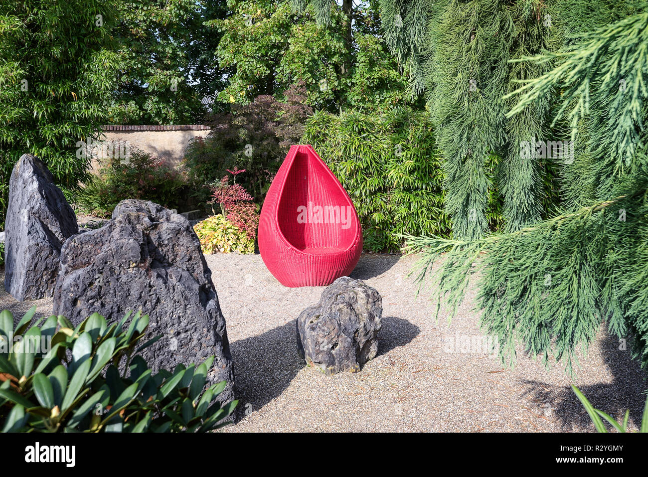 Red design chair to enjoy the sun in the beautiful autumn garden in The ...