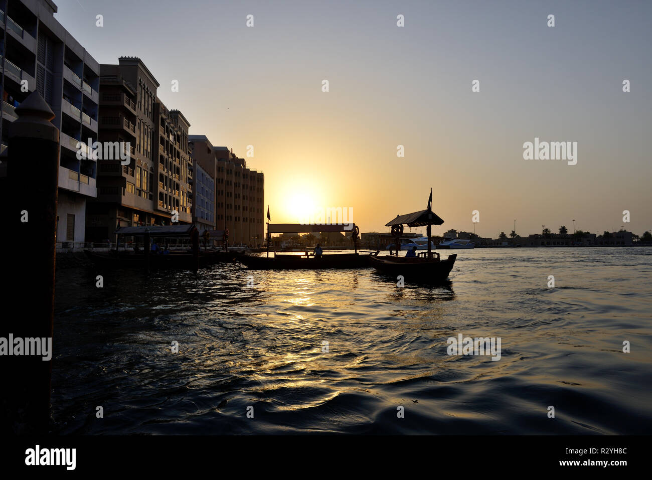 The traditional Abra boat in Dubai Creek in sunset, United Arab ...