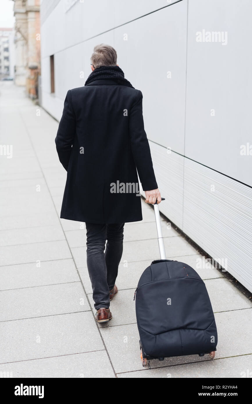 Pulling suitcase hi-res stock photography and images - Alamy