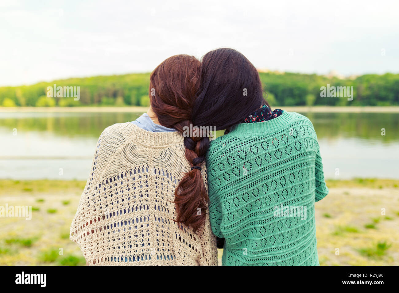 Back view sisters watching beautiful landscape on the horizon with hair ...