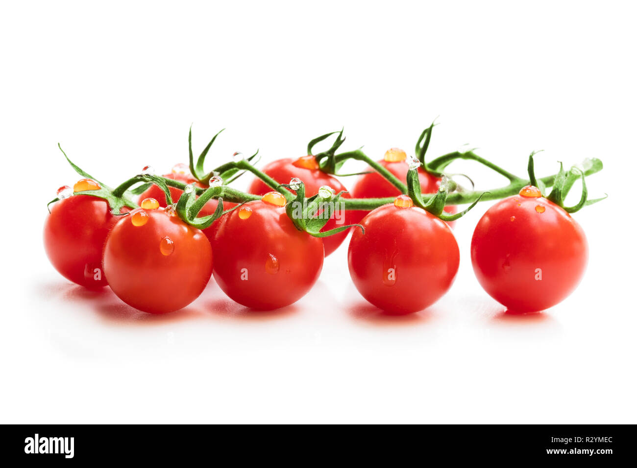 Bunch of fresh red cherry tomatoes with water drops isolated on white ...