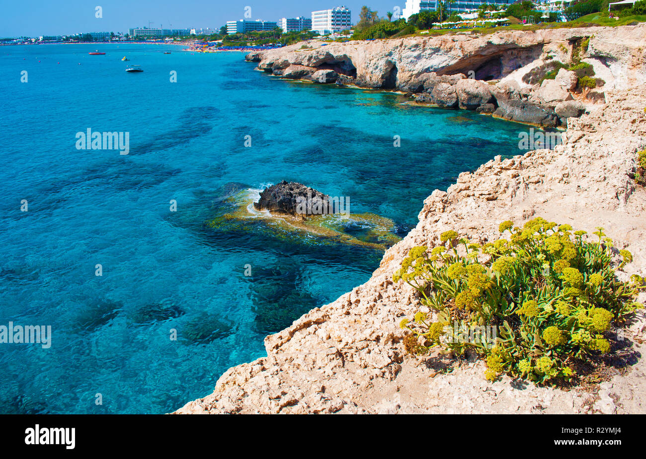View on Agia Napa. Yellow stone cliffs near transparent crystal clear ...