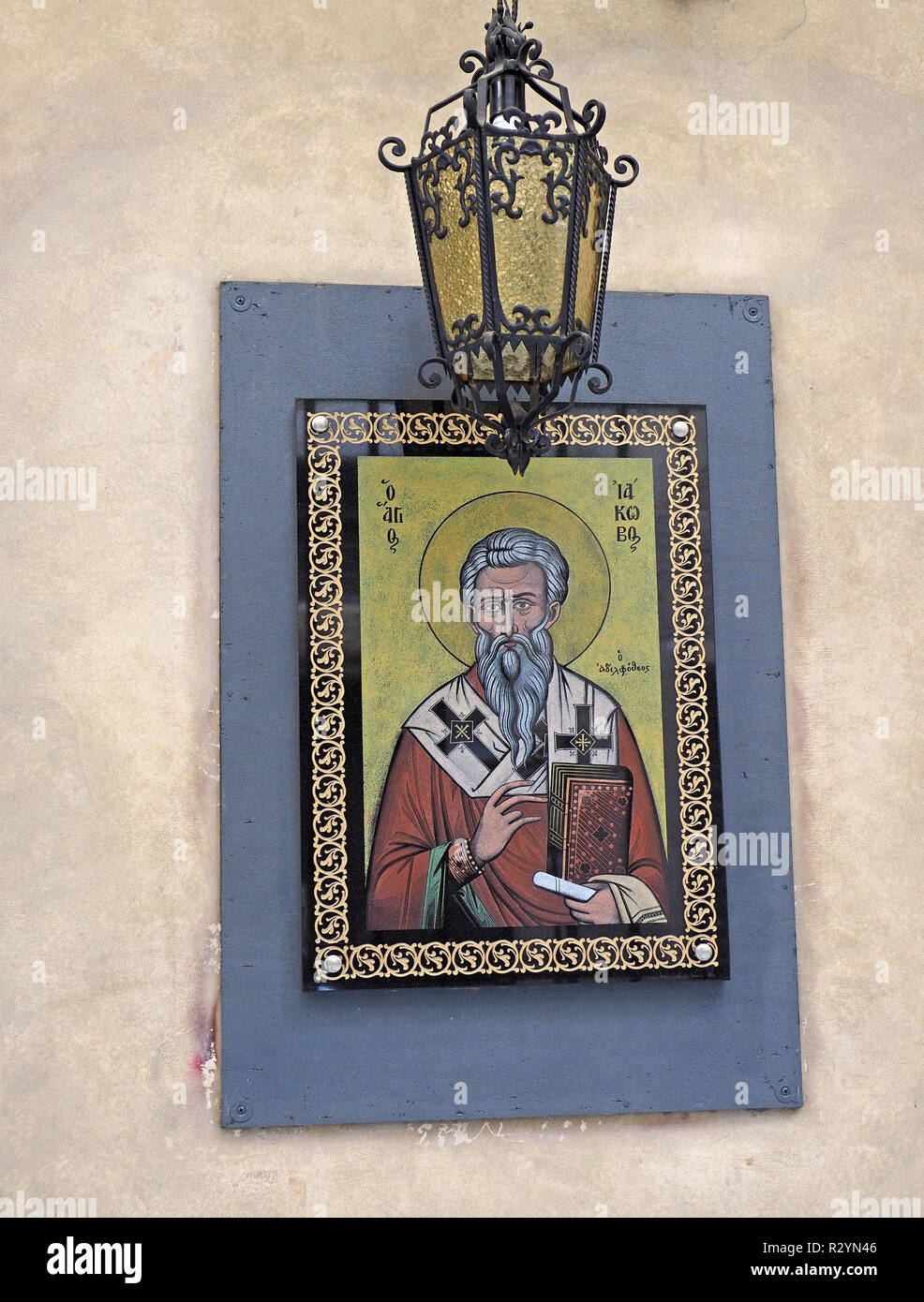street lamp and religious iconography of fresco on wall of building in ...