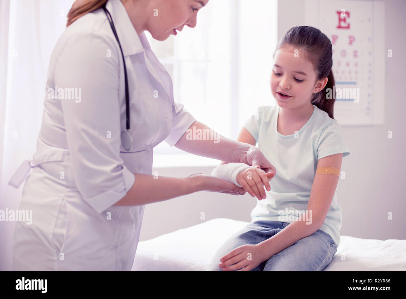 Dark-haired little girl coming to doctor after breaking her arm Stock ...