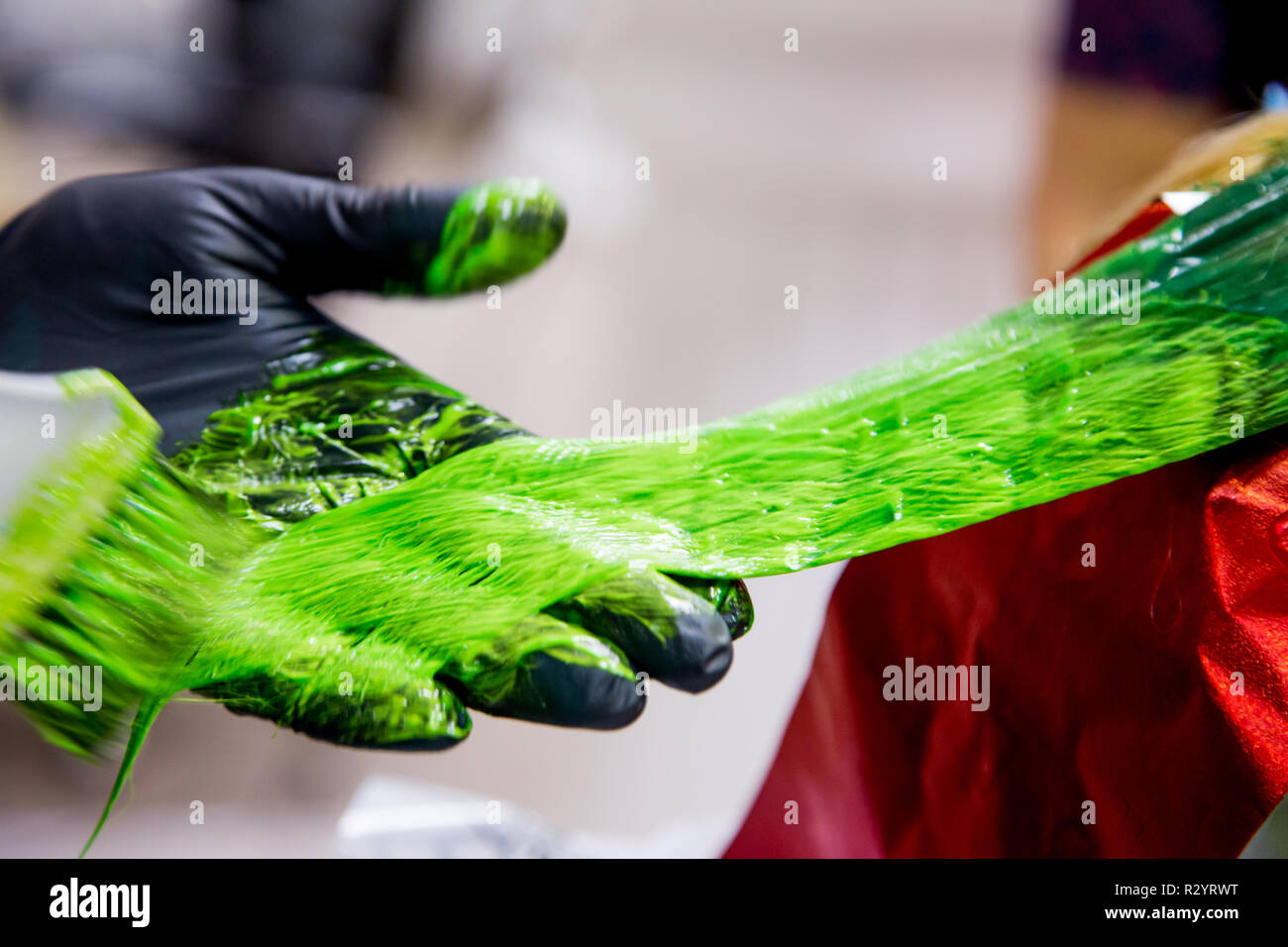 Professional hairdresser dyeing hair. Multicolor Fluorescent staining ...