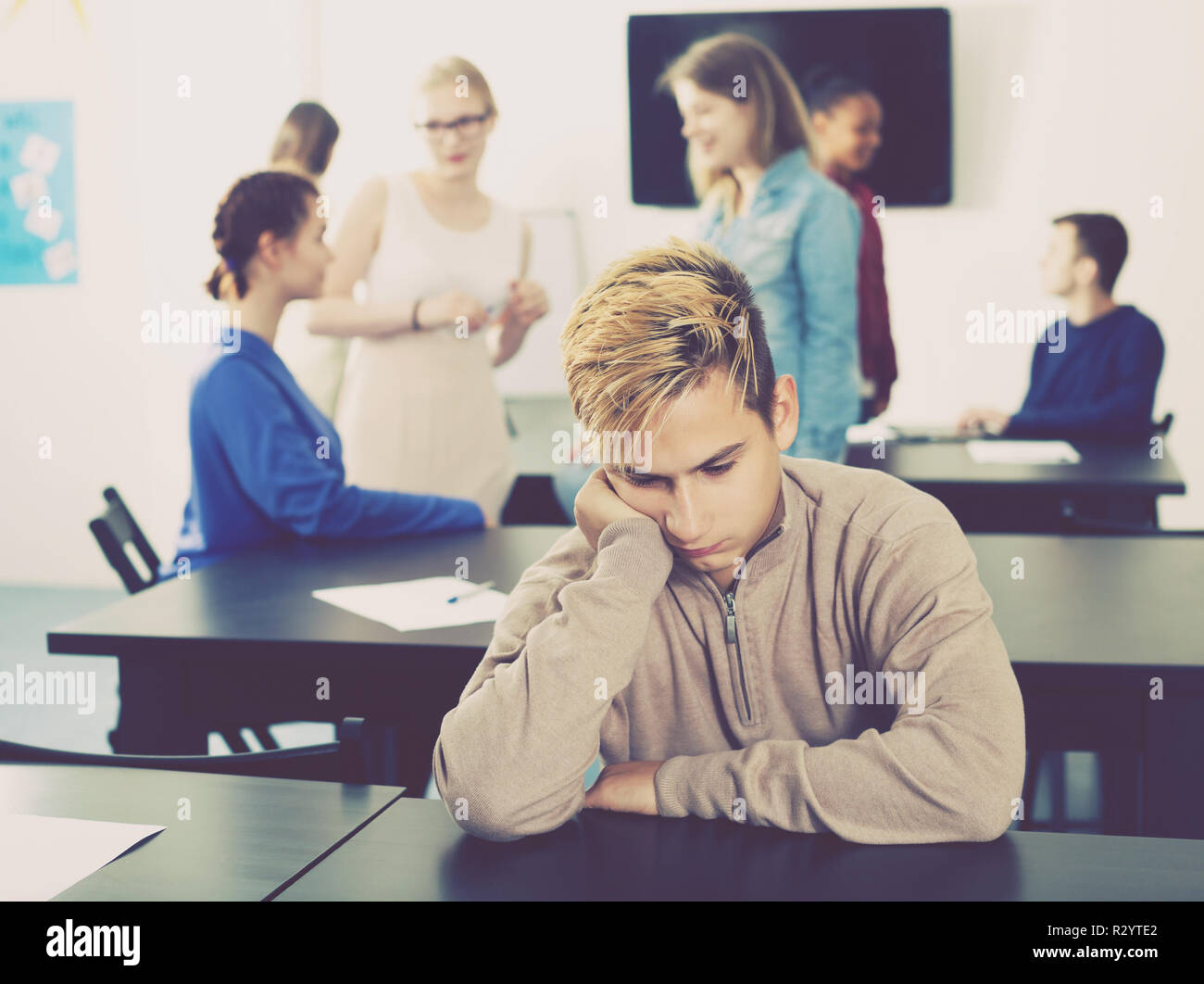 Boy student feeling uncomfortable at break between classes Stock Photo ...