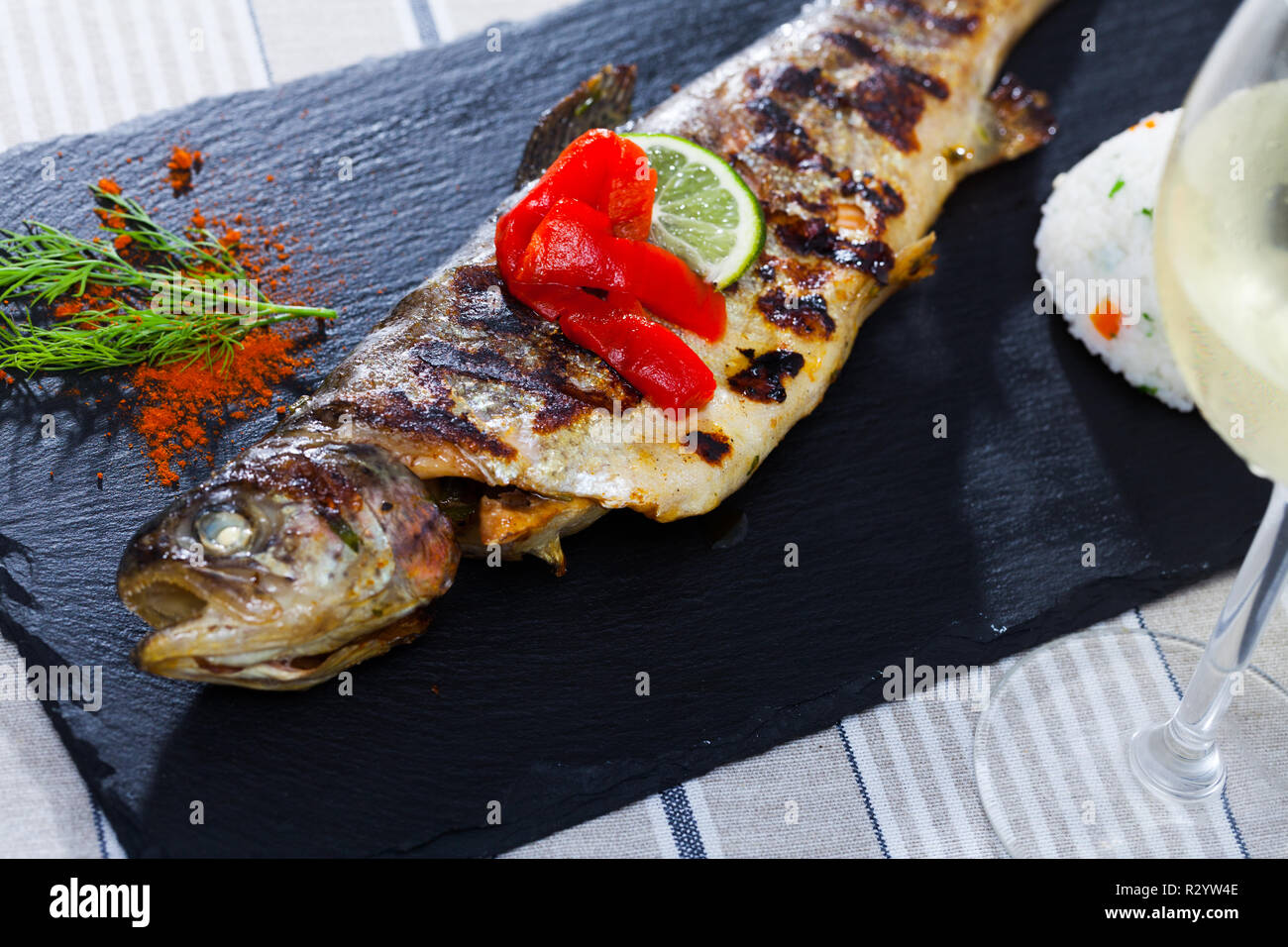 Delicious fried trout fish with white rice, fresh vegetables and lime ...
