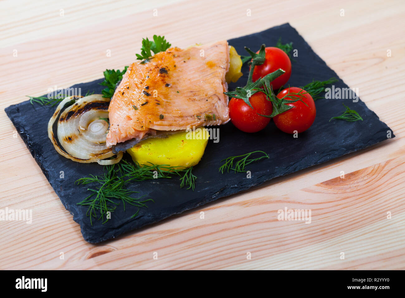 Deliciously fried trout fillets with potatoes, cherry tomatoes and ...