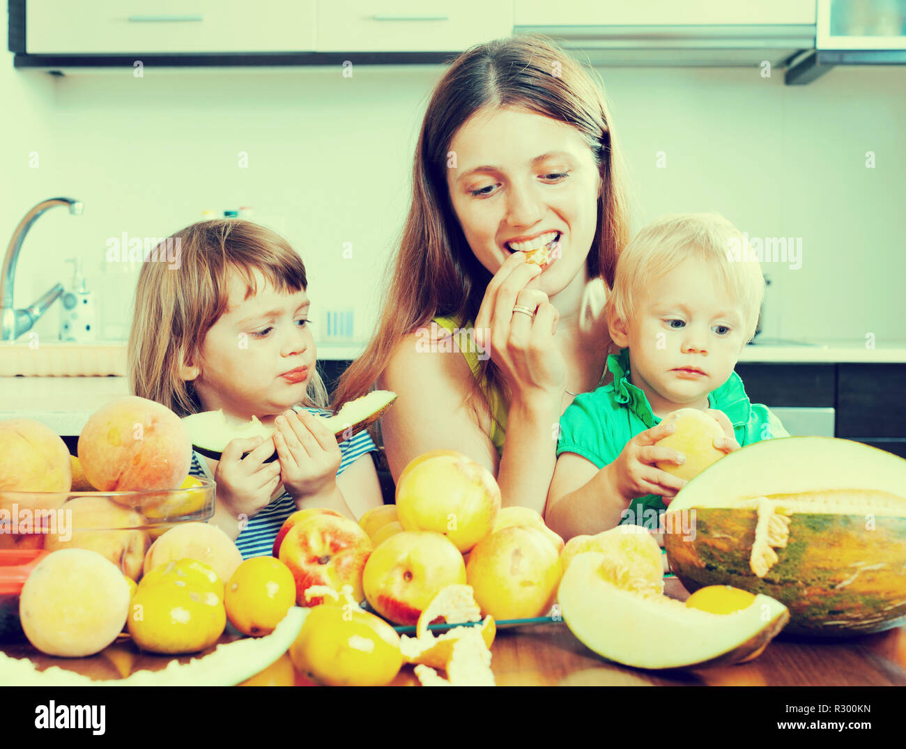 Ordinary family eating melon and other fruits at home Stock Photo - Alamy