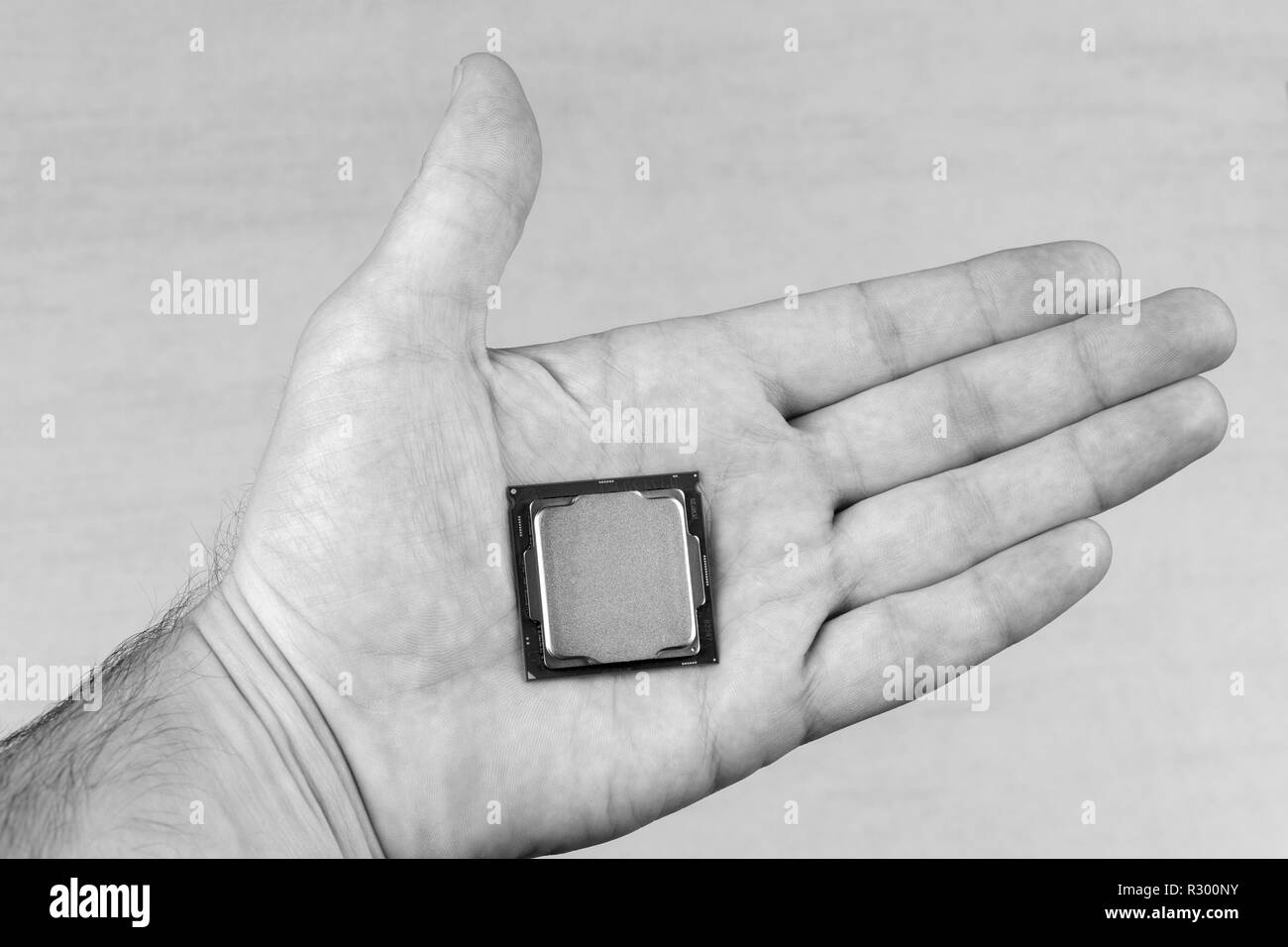 desktop processor 8th gen on a male palm on grey background closeup top ...