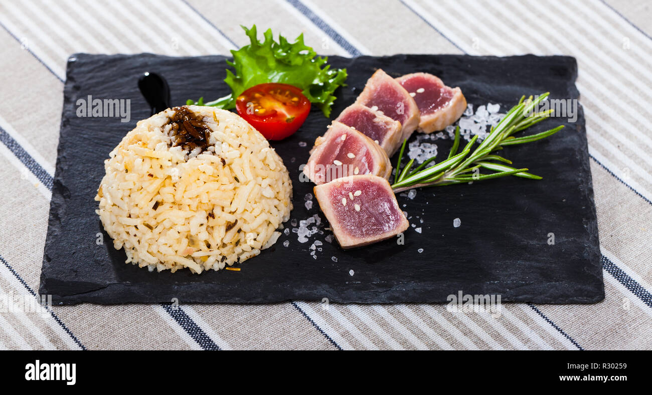 Image of deliciously lightly fried tuna with rice, served with greens ...