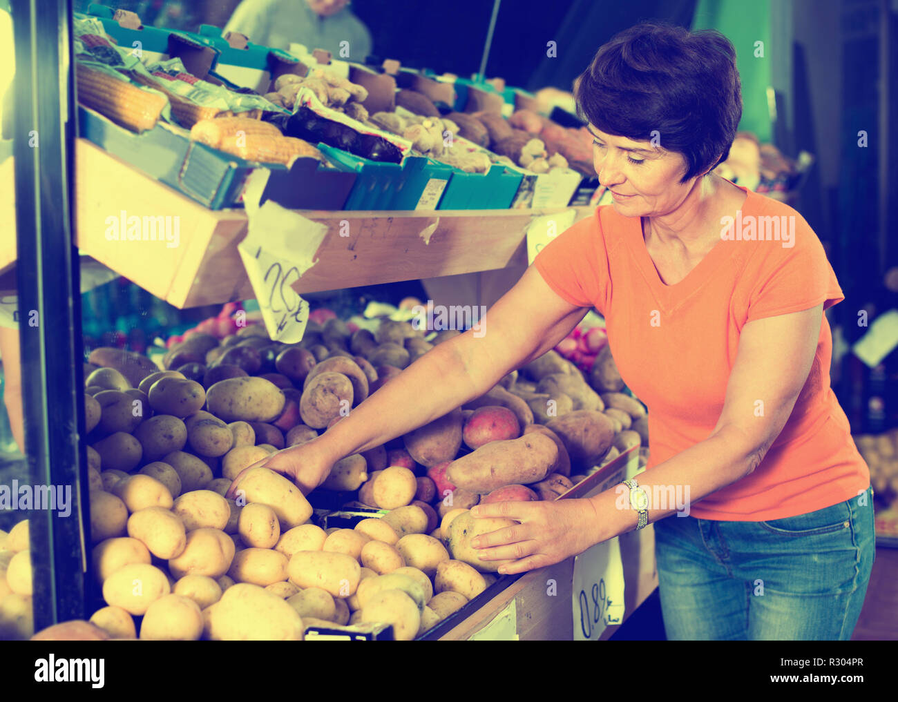 Smiling female choosing potato hi-res stock photography and images - Alamy