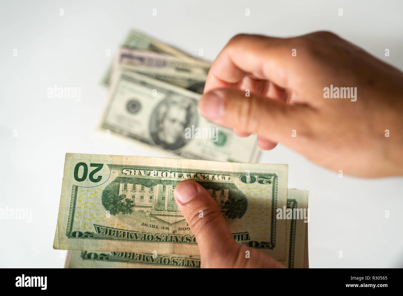Selective focus of hands counting dollar bills isolated on white ...