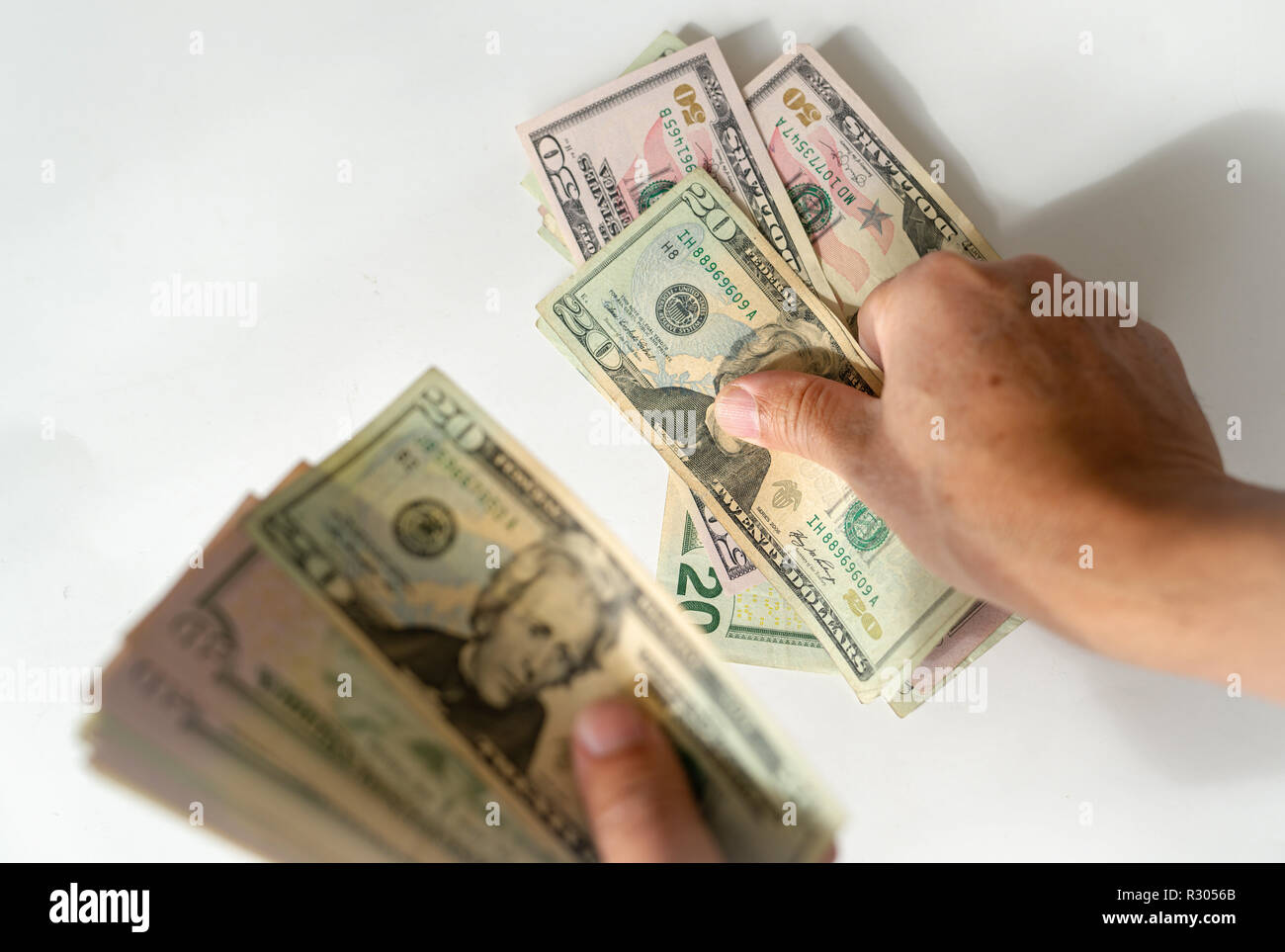 Selective focus of hands counting dollar bills isolated on white ...