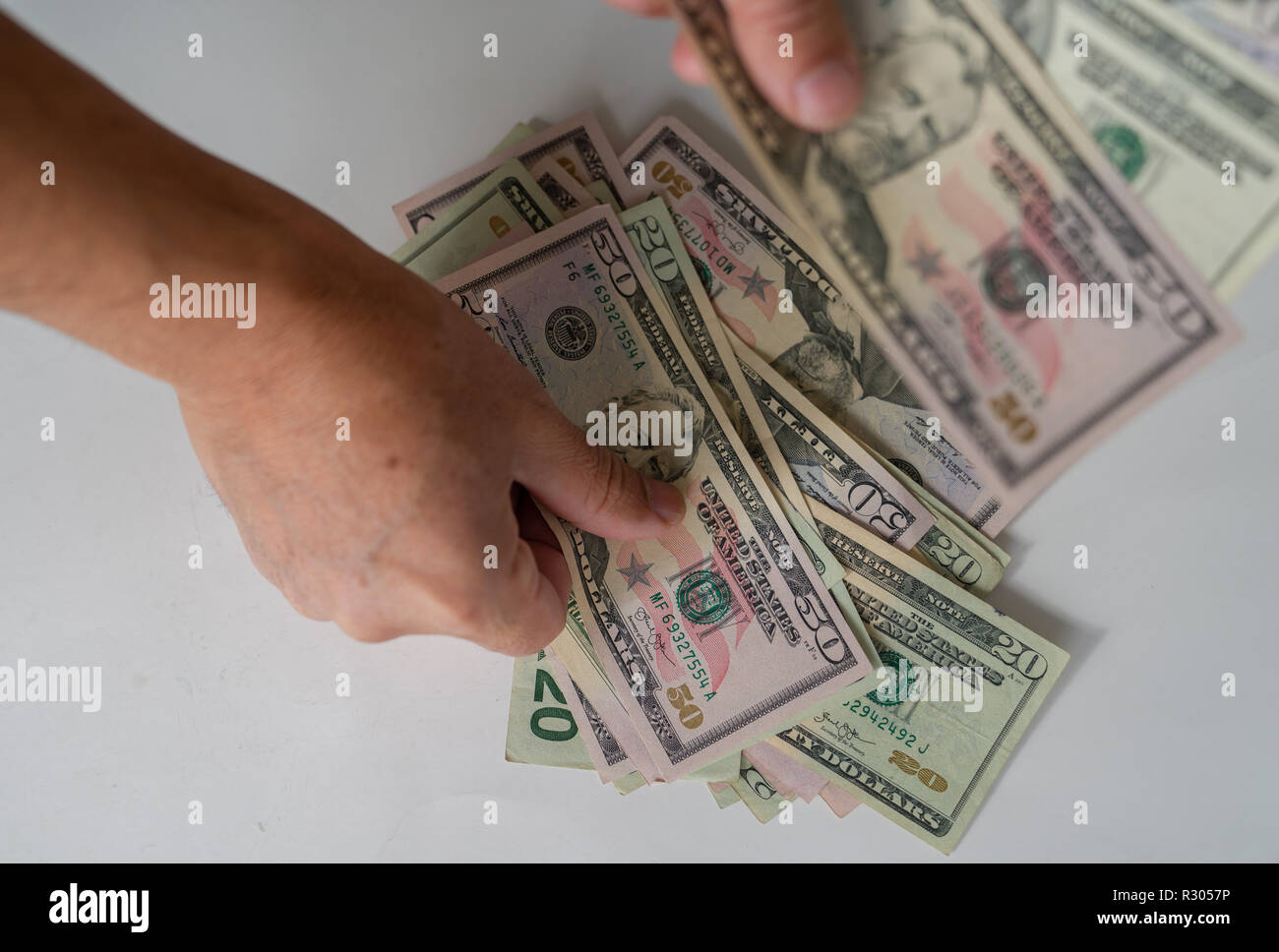 Selective focus of hands counting dollar bills isolated on white ...