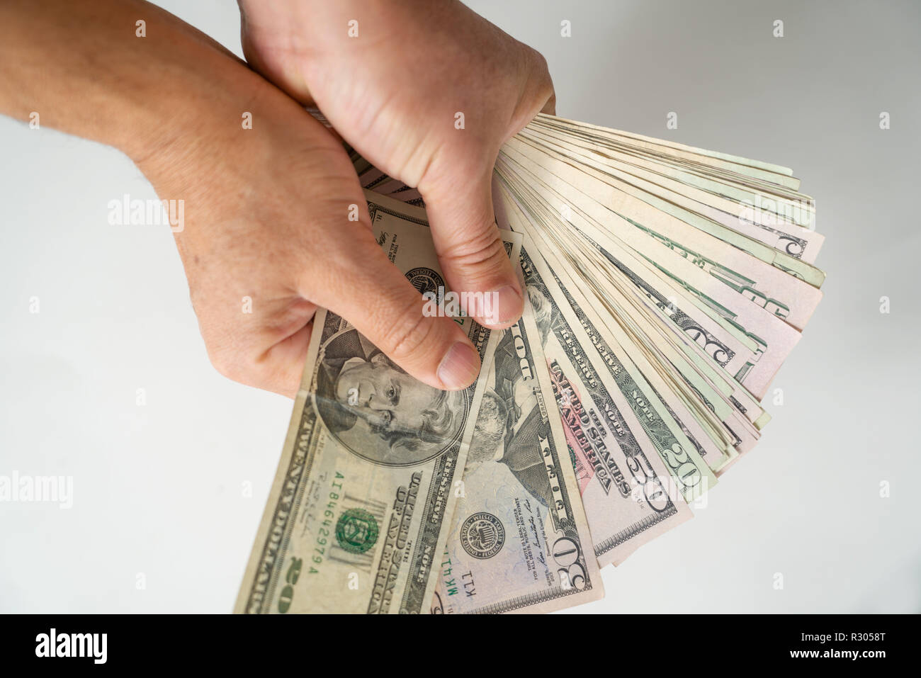 Hand holding dollar bills with white background Stock Photo - Alamy