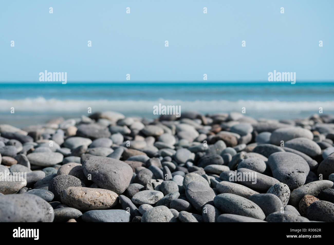 pebble stone beach - stones at ocean coast Stock Photo - Alamy