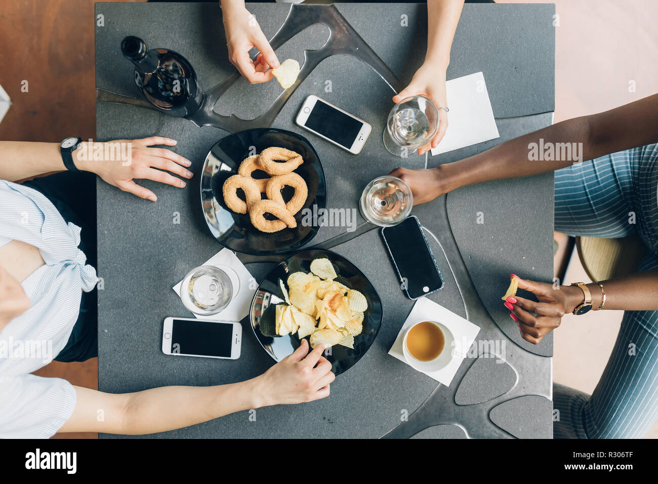 overhead view three young woman indoor having happy hour after work ...