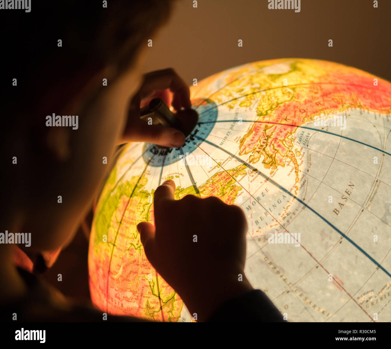 looking for a location on an earth model map Stock Photo - Alamy