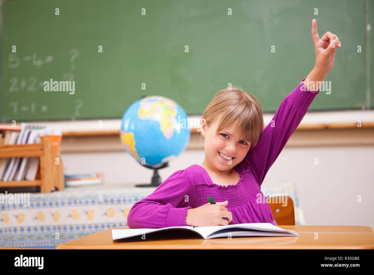 Smart student raising hand question hi-res stock photography and images ...