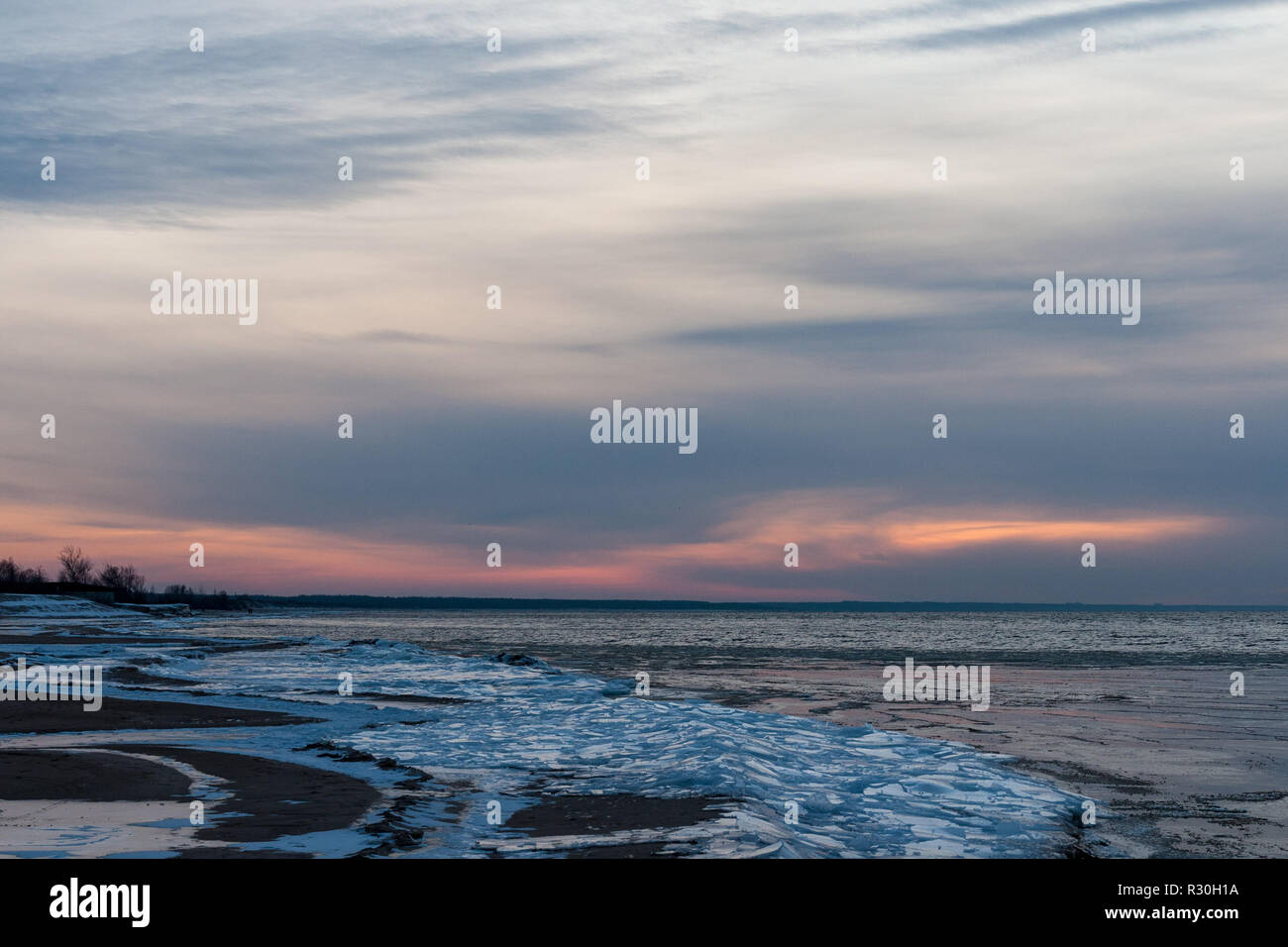 frozen sea side beach panorama in winter with lots of ice and snow in ...