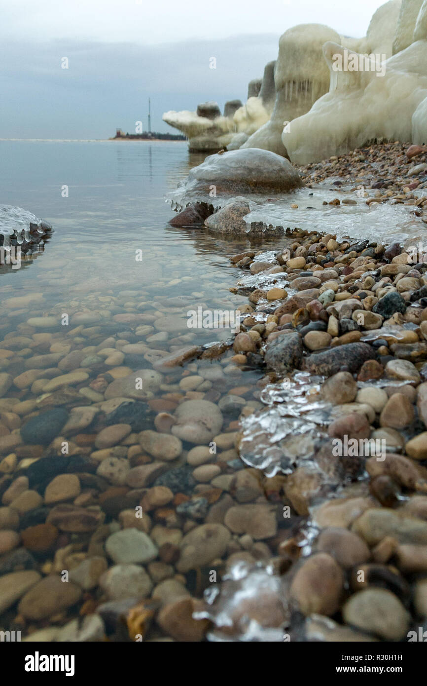 frozen sea side beach panorama in winter with lots of ice and snow in ...