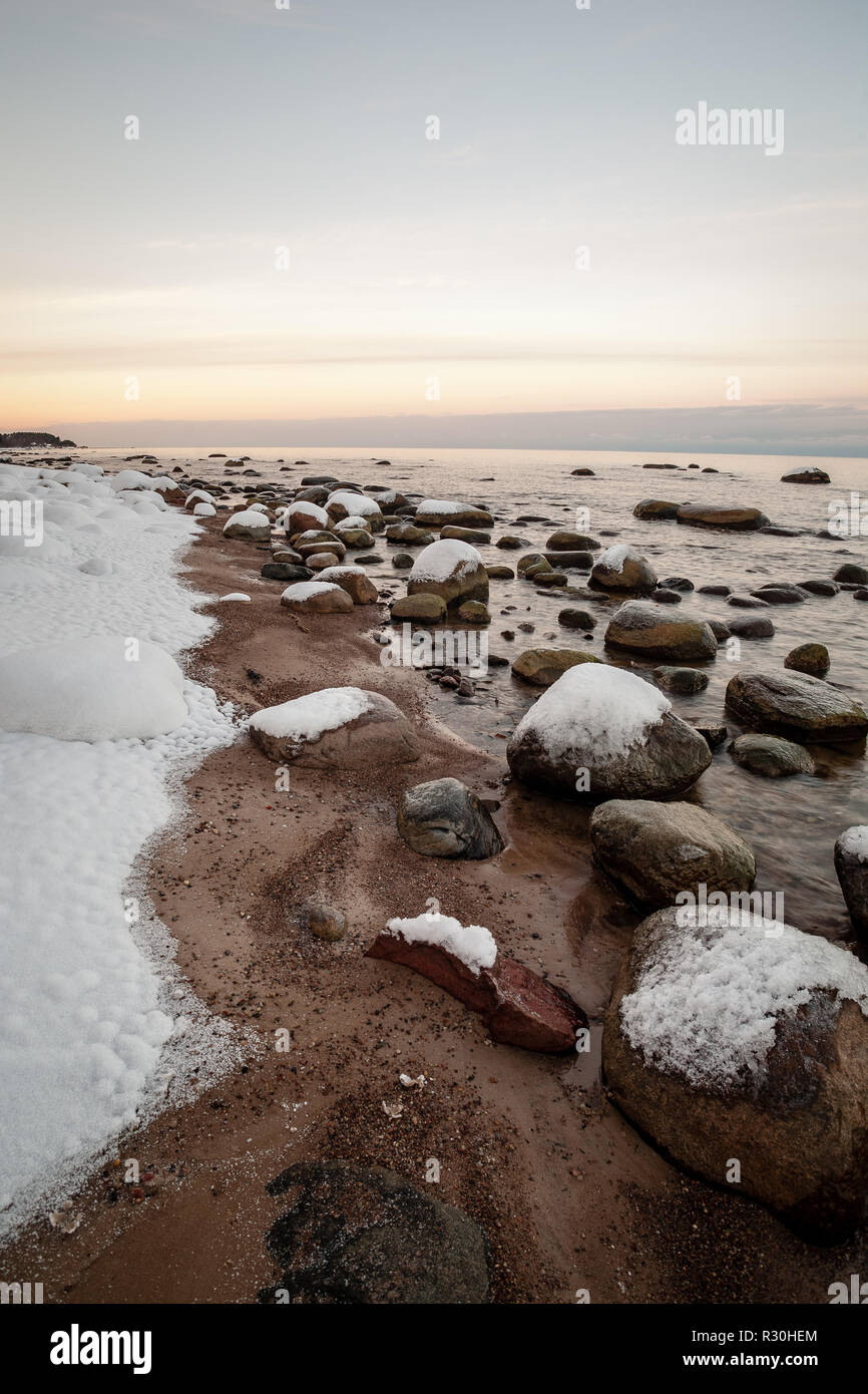 frozen sea side beach panorama in winter with lots of ice and snow in ...