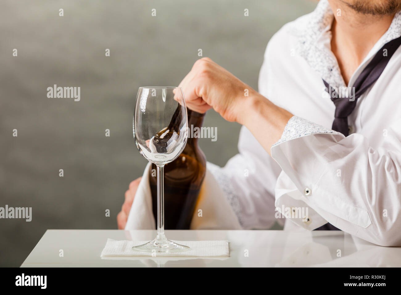 Male waiter or butler serving pouring wine into glass Stock Photo - Alamy
